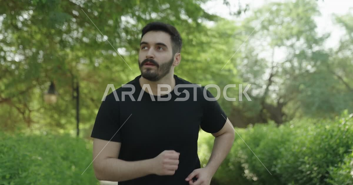An Arab man doing morning sports in the open air, jogging, exercising ...