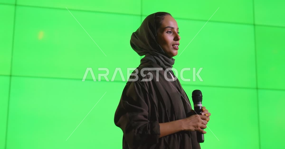 A Saudi Arabian Gulf woman standing on the field stage in front of the ...