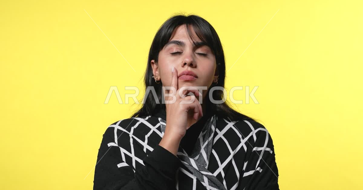 A Saudi Arabian Gulf girl, facial and hands gestures indicating ...