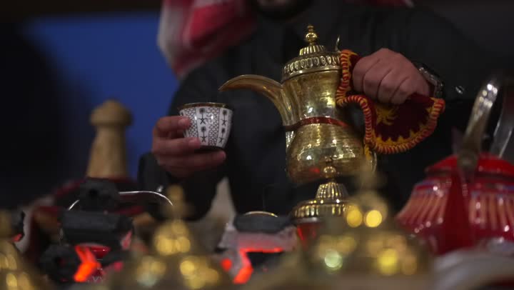 Following the authentic traditions in making Arabic beverages, using ...