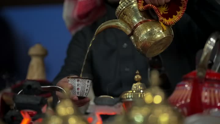 Following the authentic traditions in making Arabic beverages, using ...