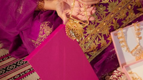 Gold jewelry at showcase of jewelry shop. Gold items in shop windows ...