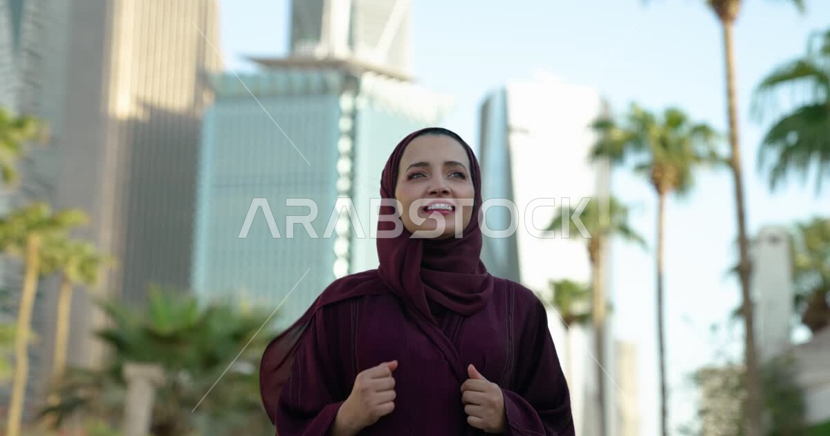 A Saudi Arabian Gulf woman on a leisure tour next to the towers of King ...