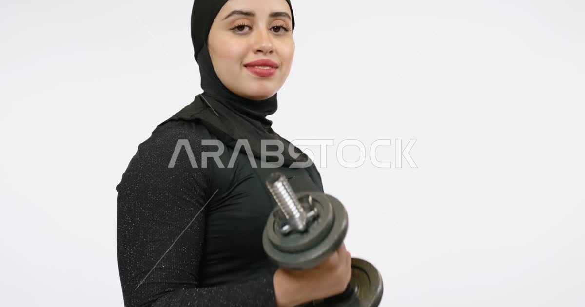 Portrait of a veiled Saudi Arabian woman wearing a sportswear ...