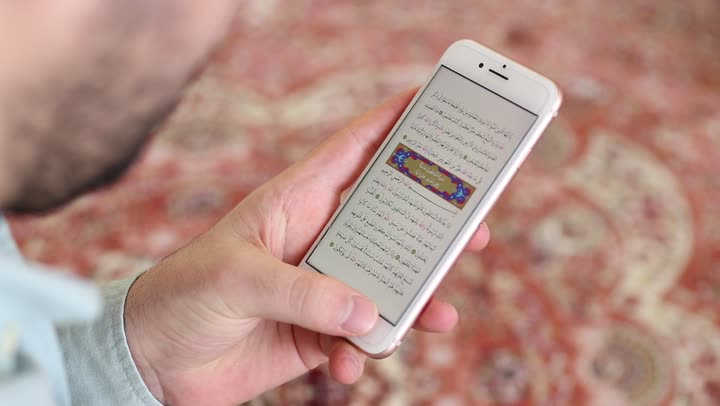 The electronic Quran, recited and melodious, a close-up shot of an Arab ...