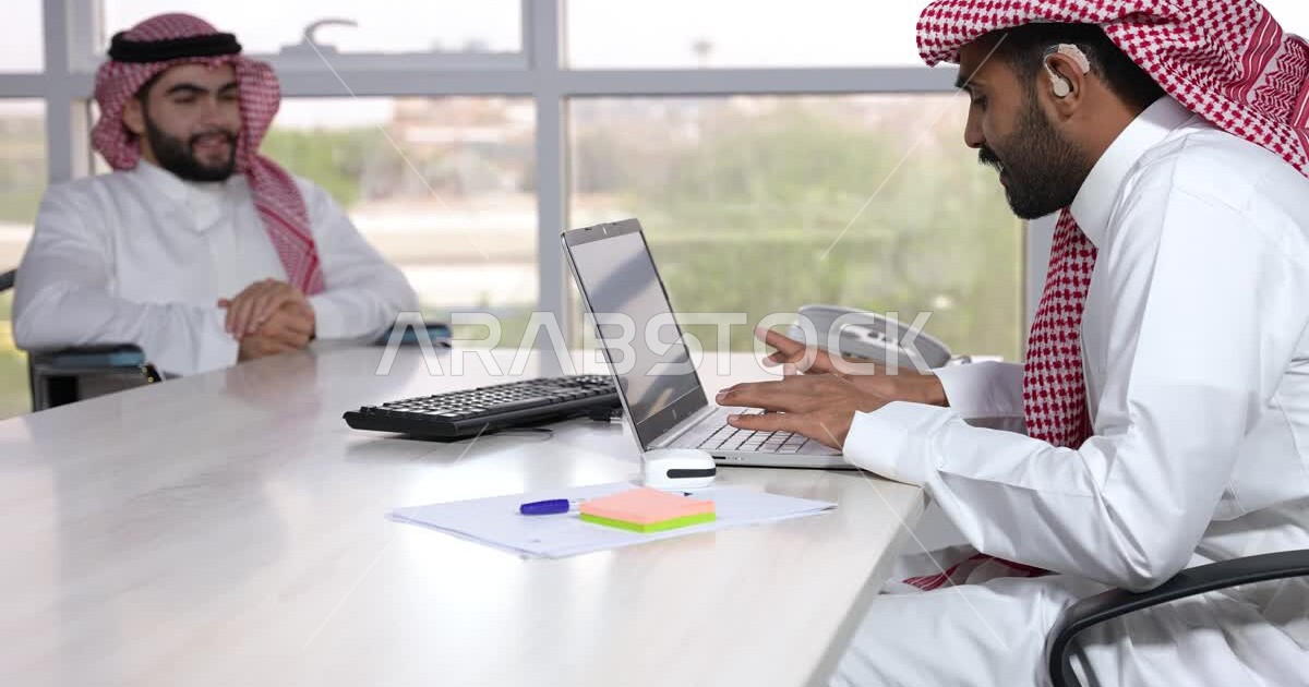 A Saudi Arabian Gulf employee with deafness wears a hearing aid to help ...