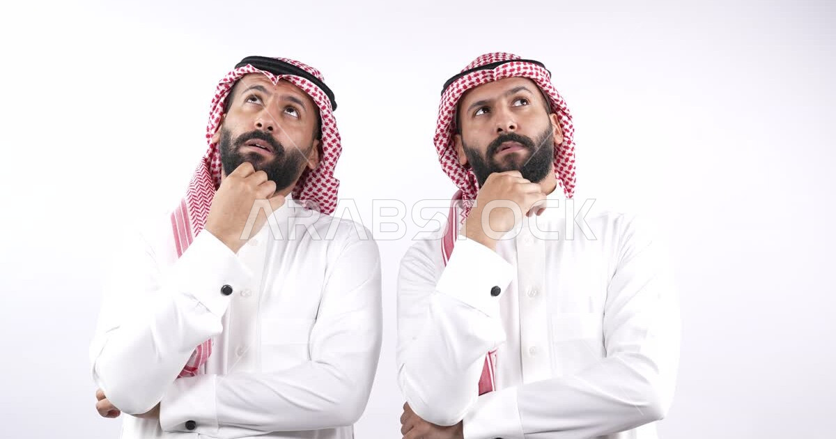 Portrait of two Saudi Arabian Gulf twin men, thinking about the future ...