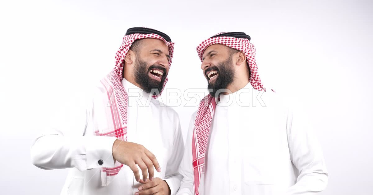 Portrait of two Saudi Arabian Gulf twin men laughing loudly, laughing ...