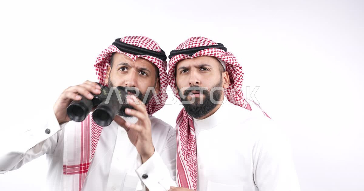 Portrait of two Saudi Arabian Gulf twin men wearing the Saudi thobe and ...