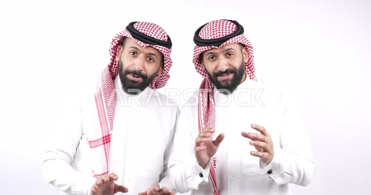 Portrait of two Saudi Arabian Gulf Arab twin men, speaking calmly ...