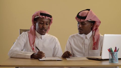 Using a laptop, research and scientific studies, a portrait of a Saudi ...