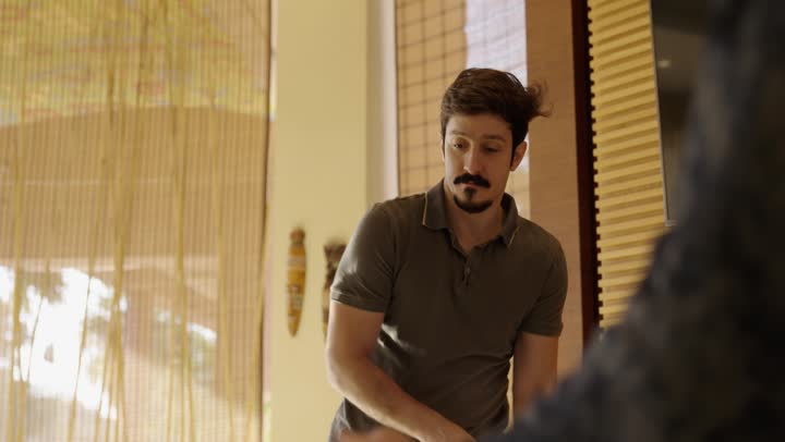 A Saudi Gulf Arab family is playing bowling in a warm atmosphere. The ...