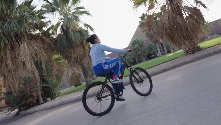 A Saudi Arabian Gulf man in traditional attire is explaining to his ...