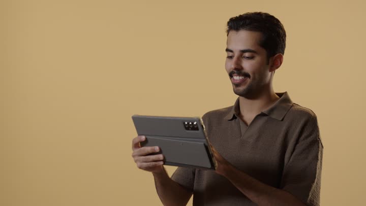A portrait of an Arab Saudi Gulf man in traditional attire standing ...