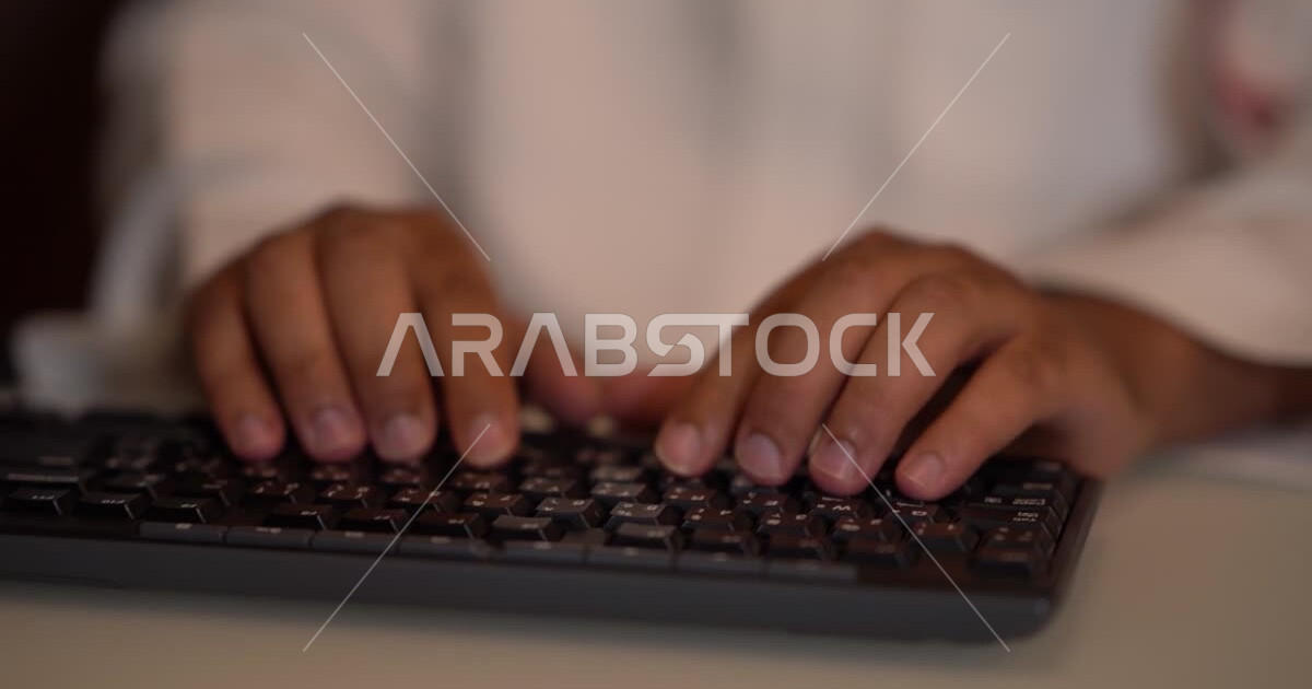 Close-up photography of the hand of a Saudi Arabian Gulf man using a ...