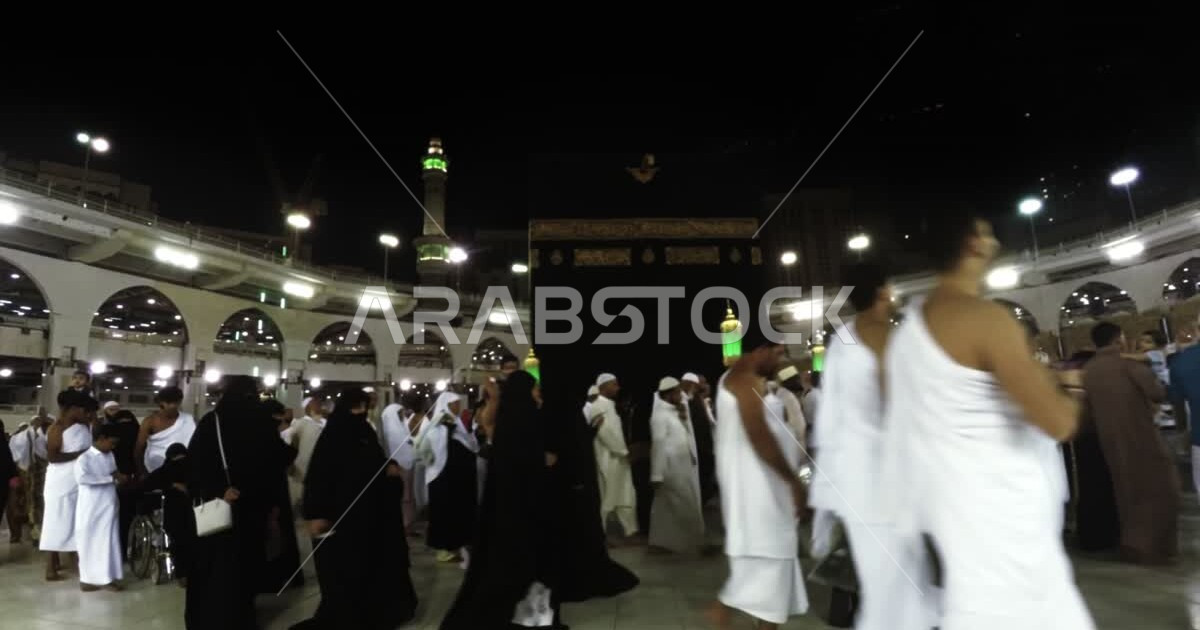 Muslim pilgrims in Ihram dress performing Hajj, performing the rituals ...