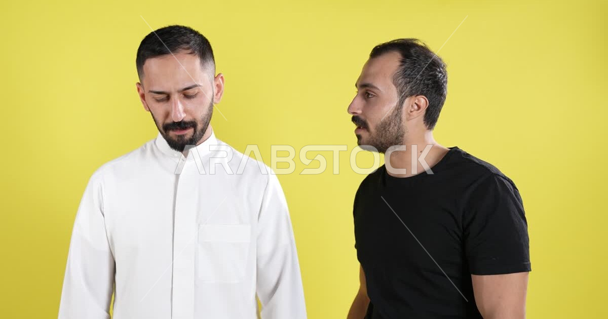 A Saudi Arabian Gulf man is comforting his sad friend, trying to calm ...