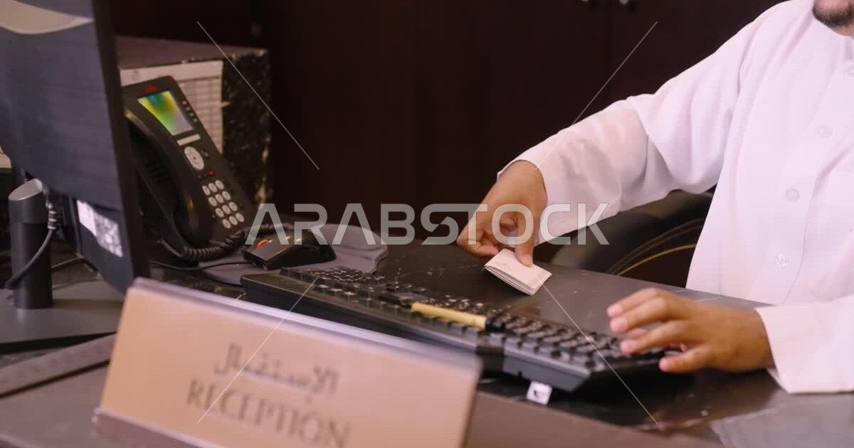 A Saudi Arabian Gulf receptionist who happily delivers the hotel room ...