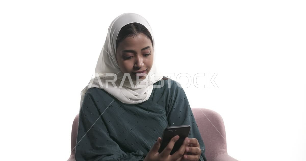 A Saudi Arabian Gulf woman using a mobile phone, calling and ...