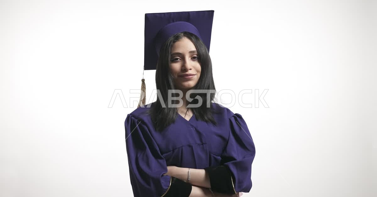 Portrait of a Saudi Arabian Gulf student wearing a graduation dress and ...