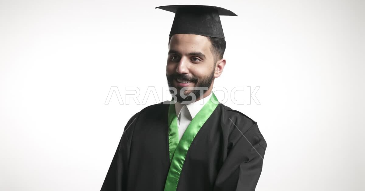 Portrait of a Saudi Arabian Gulf student wearing graduation gown ...