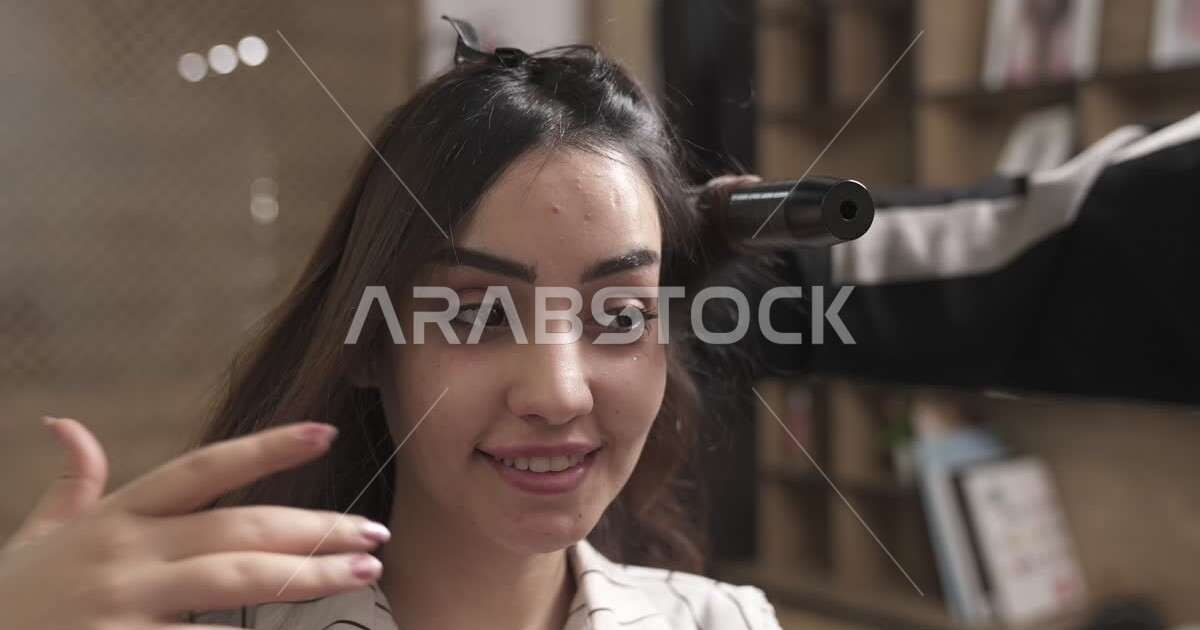 A Saudi Arabian Gulf woman in a women’s beauty salon, a hairdresser ...