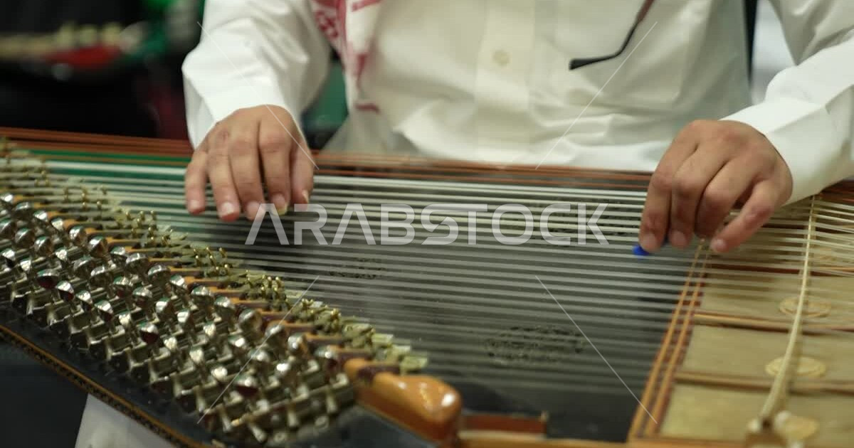 Close-up of a man playing the stringed zither, a musical instrument ...