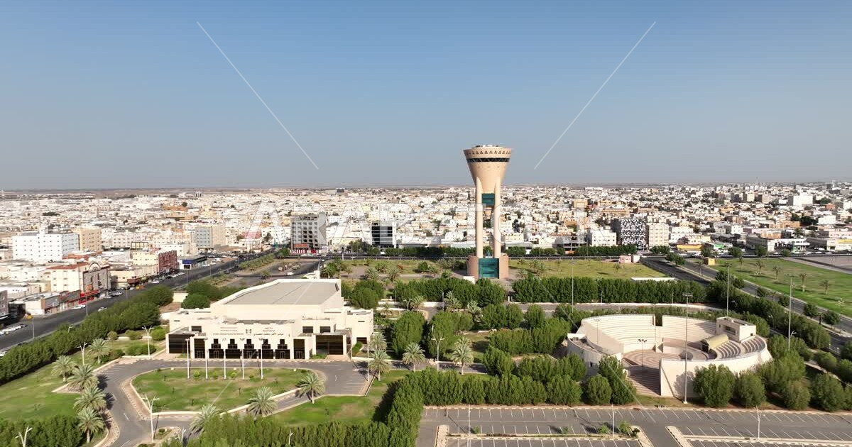 Tabuk Tower in the city of Tabuk, Saudi Arabia, trees and green plants, roads and streets ...