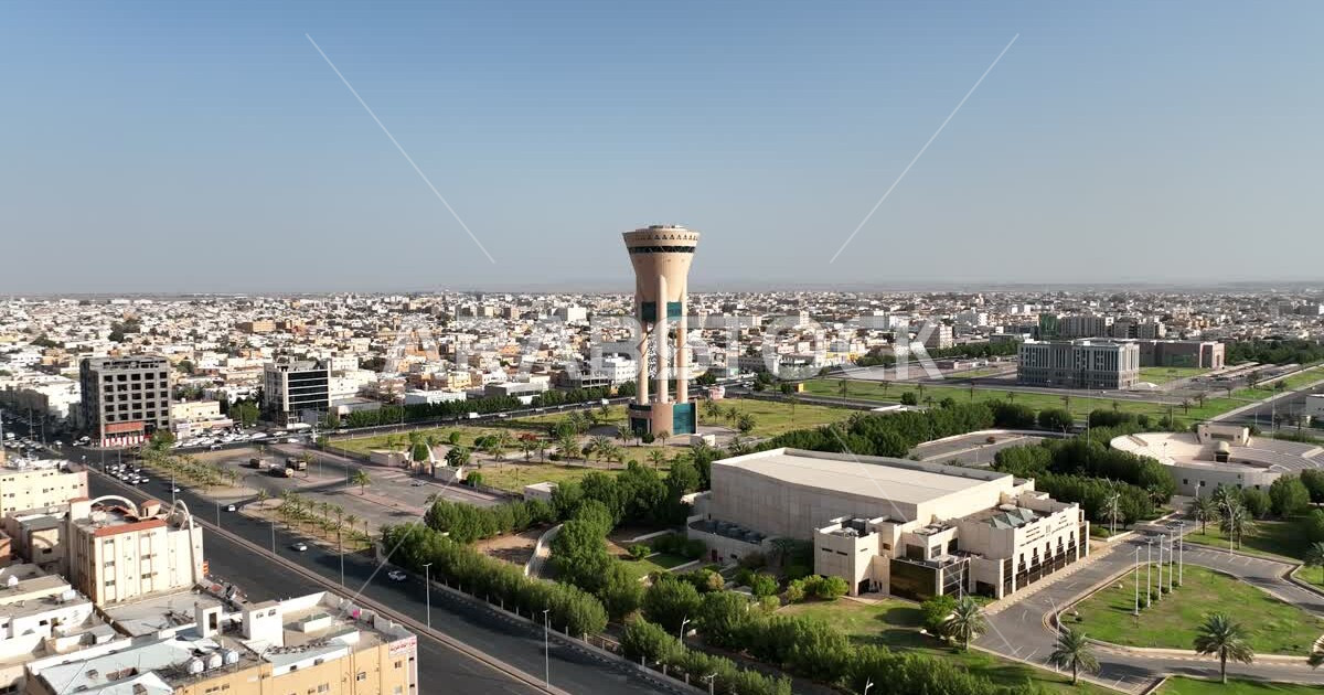 Tabuk Tower in the city of Tabuk, Saudi Arabia, trees and green plants, roads and streets ...