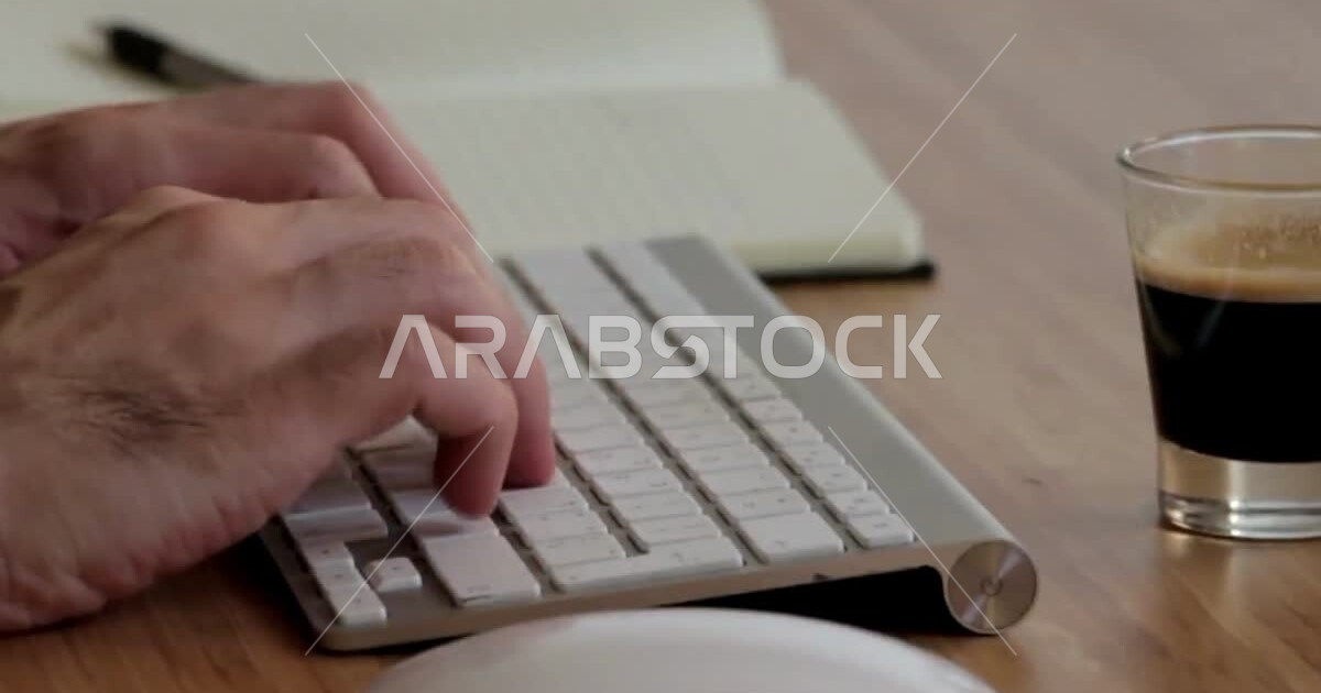 Close-up depiction of a man's hand using the keyboard, typing on the keyboard to enter data ...