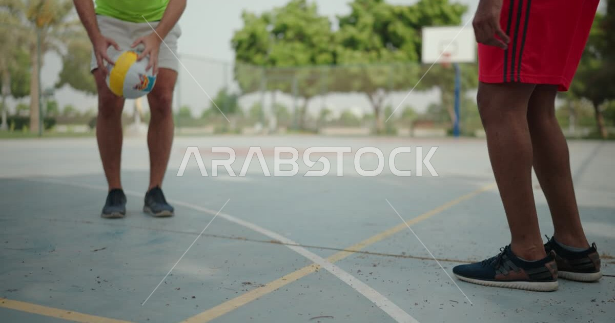 A team of Saudi Arab Gulf friends playing football, playing football in ...