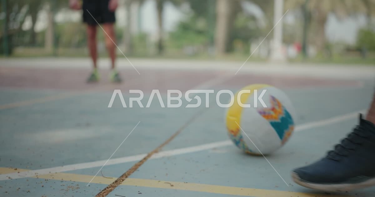 A team of Saudi Arab Gulf friends playing football, playing football in ...