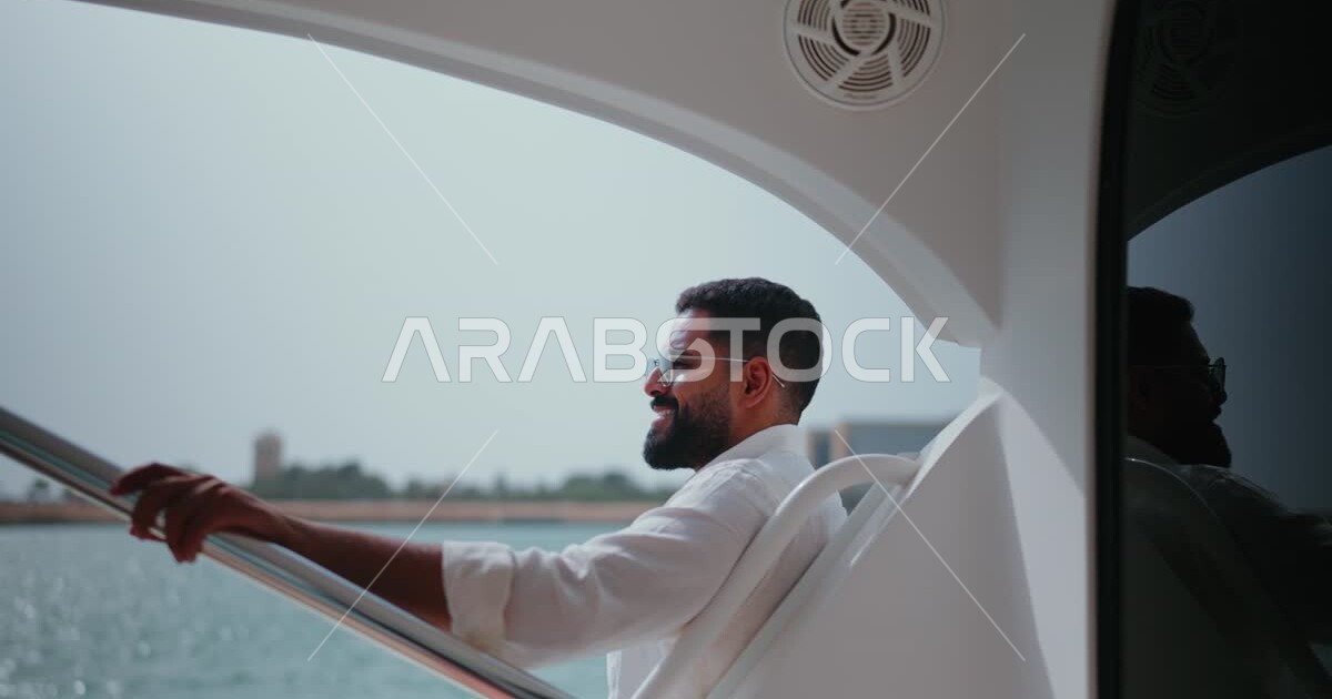 A young Saudi Arabian Gulf man on a yacht in the sea, the pleasure of ...