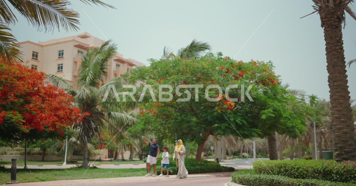 A Saudi Arabian Gulf family wandering in one of the recreational ...