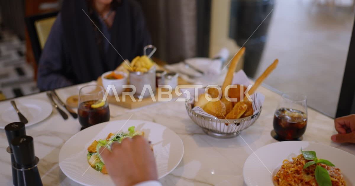 A Saudi Arabian Gulf couple sitting at the dining table in the ...
