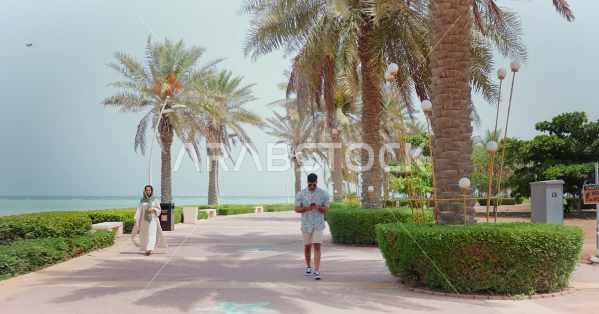A Saudi Arabian Gulf man practicing walking in the Jeddah Corniche ...