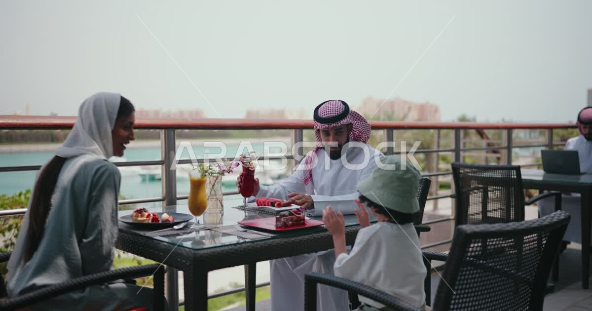 A Saudi Arabian Gulf family sitting in a café in one of the Gulf hotels ...