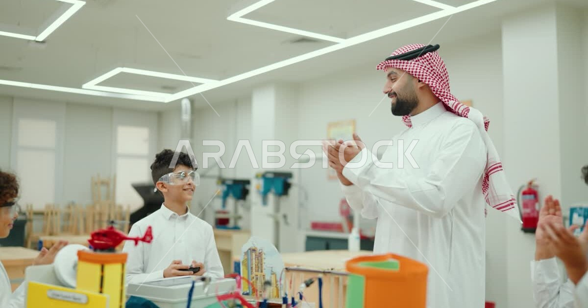 A Saudi Arabian Gulf teacher with his students in an advanced ...