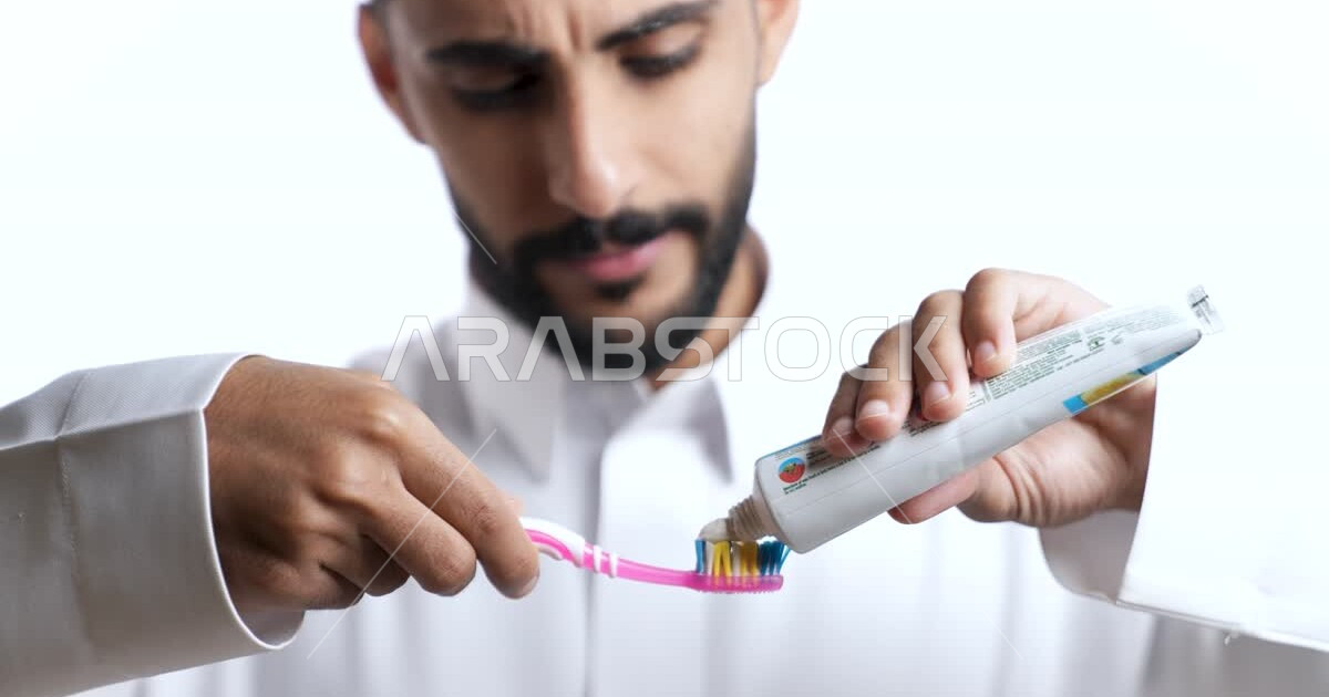 Chroma, a Saudi Arabian Gulf man, brushing his teeth with toothpaste ...