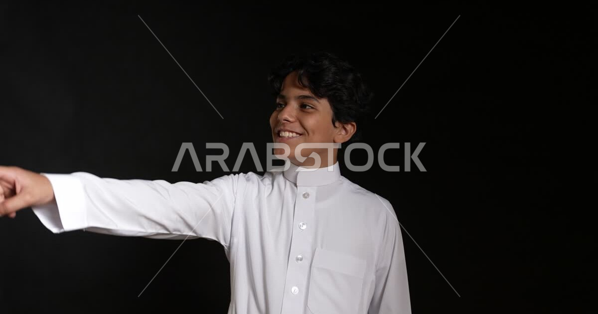 Portrait of a Saudi Arabian Gulf boy wearing the Saudi outfit, hand ...