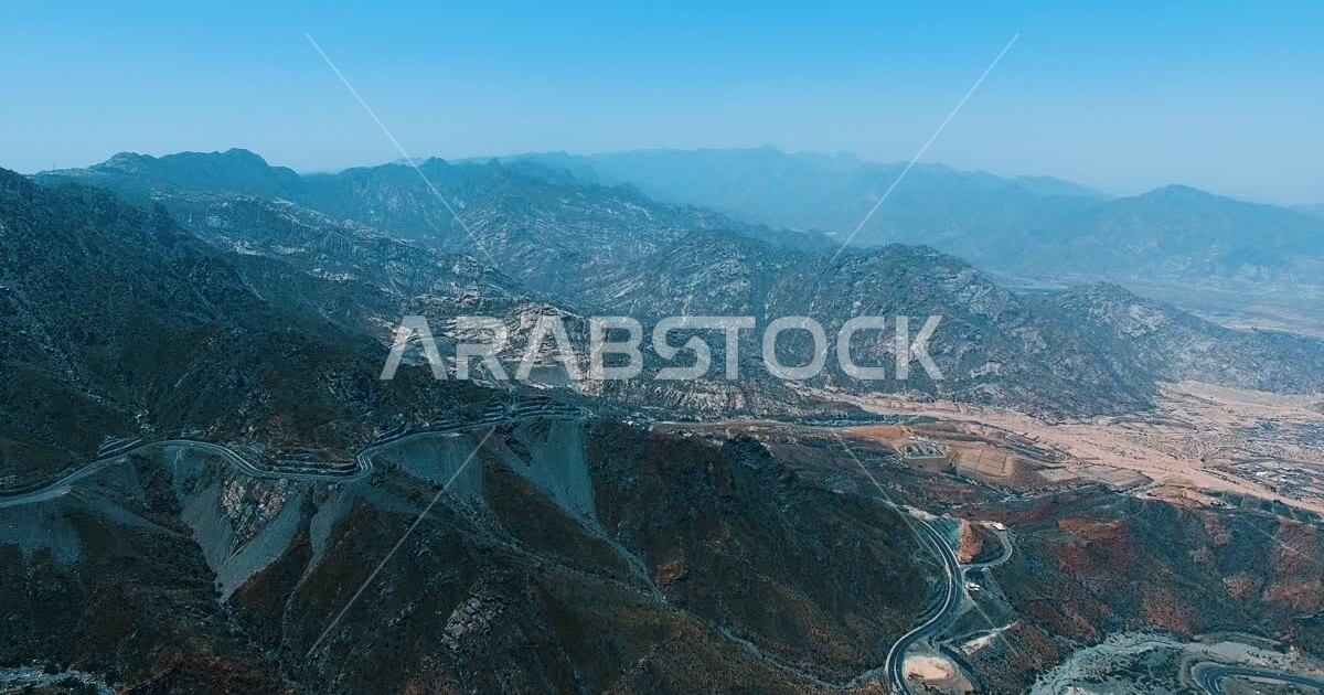 Aerial view of roads between mountains and valleys in the city of Taif ...
