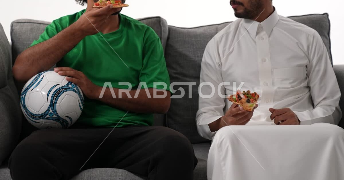 Close-up of two Saudi Arabian Gulf youths cheering for the Saudi ...
