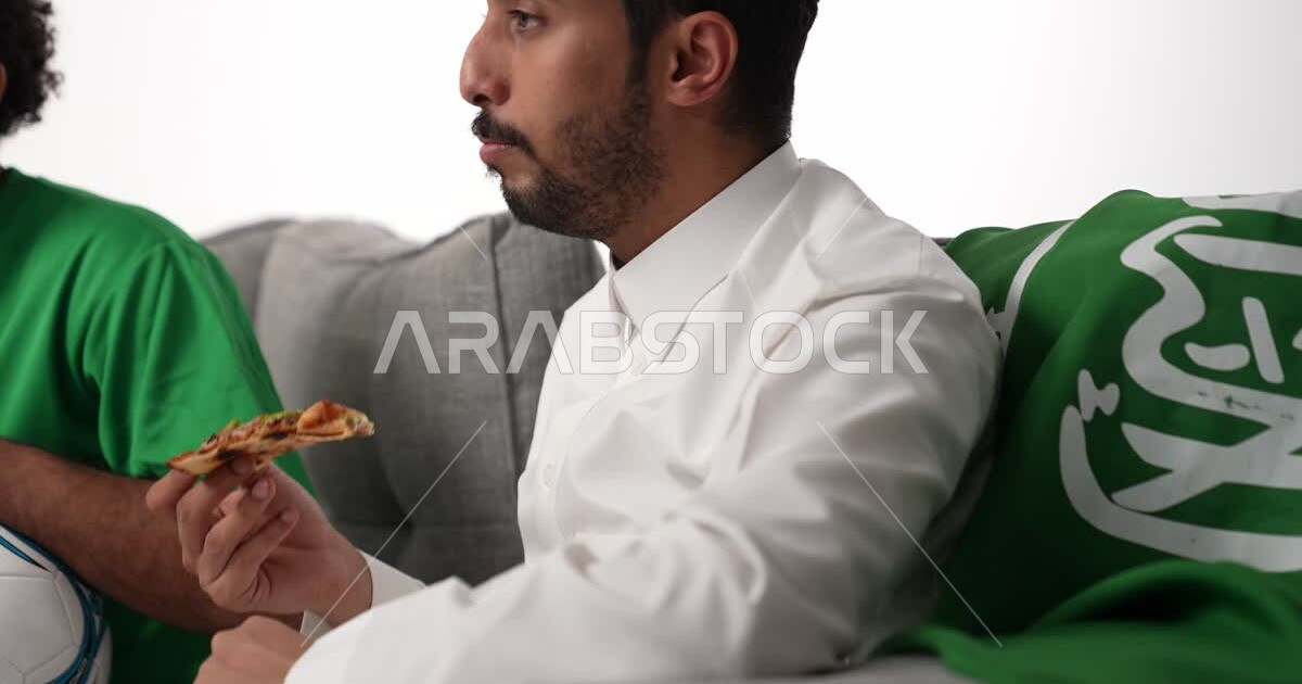 Close-up of two Saudi Arabian Gulf youths cheering for the Saudi ...