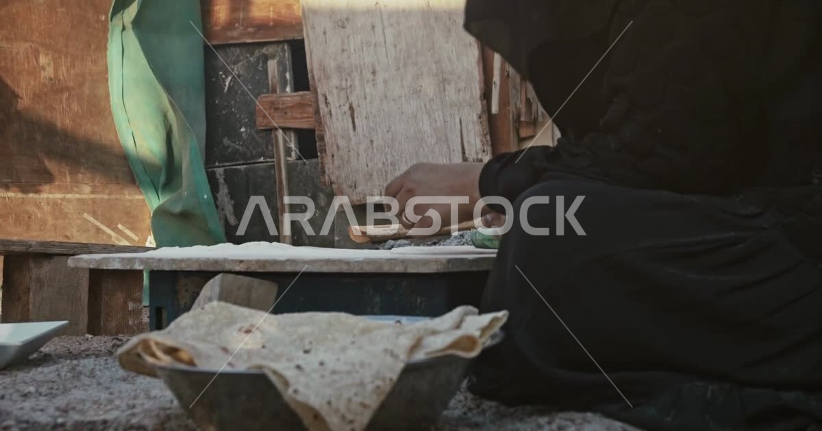 Close-up of a Saudi Arabian Gulf woman making saj bread, kneading bread ...