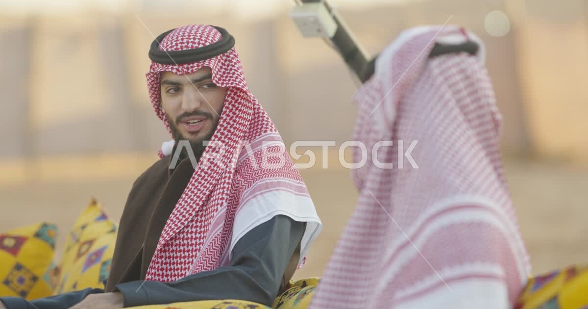 Two Saudi Arabian Gulf men dressed in warm winter clothes, dialogues ...