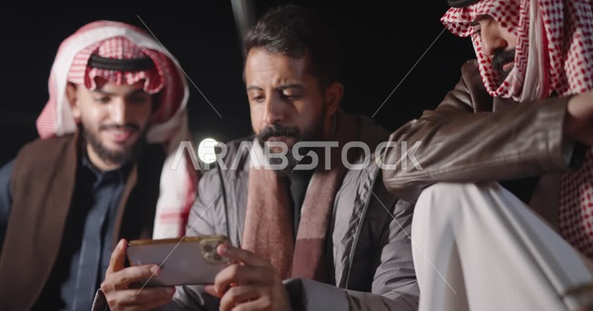 A group of young Saudi Arabian Gulf men enjoying a wild camping trip in ...