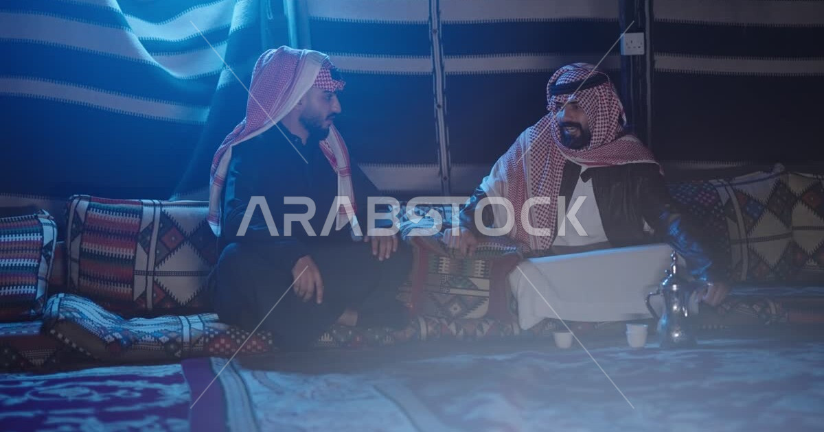Two Saudi Arabian Gulf men dressed in warm winter clothes, an Arabic ...