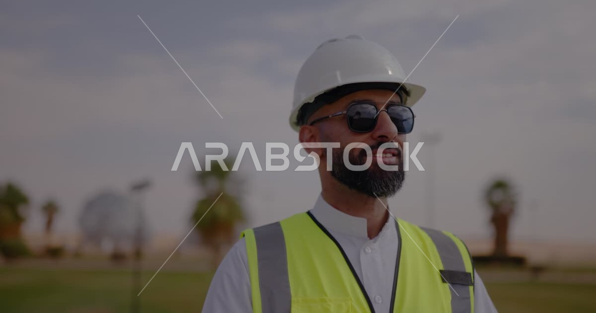 A Saudi Gulf Arab engineer, wearing a helmet and a protective vest ...