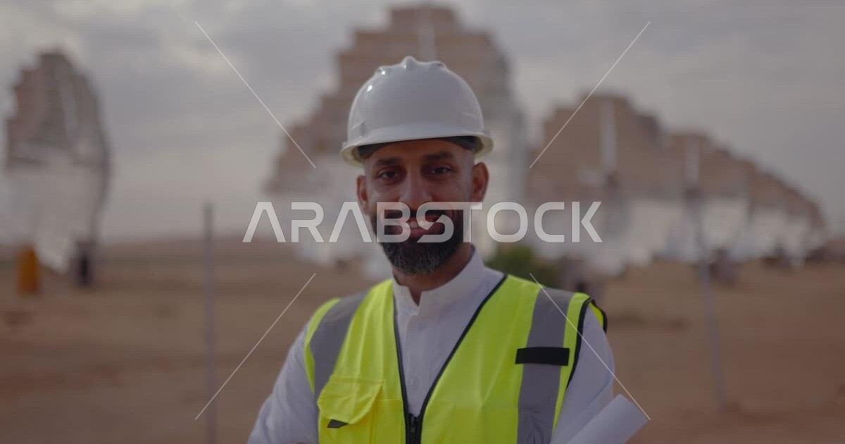 Saudi Arabian Gulf engineer, wearing helmet and protection jacket ...