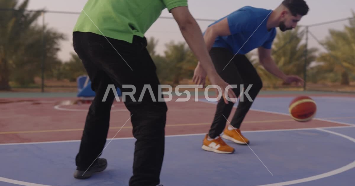A team of Saudi Gulf Arab friends playing basketball, practicing ...